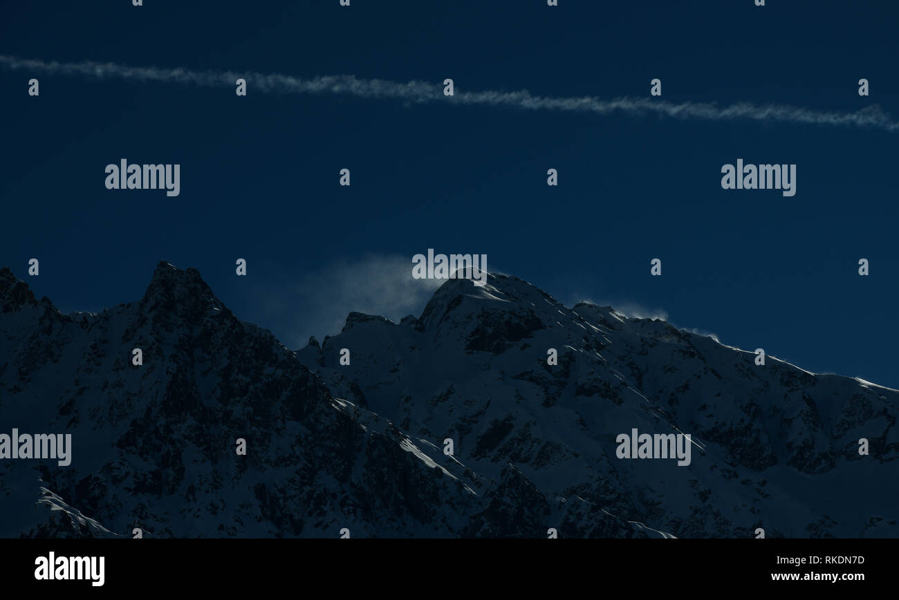 Wind blowing over snow capped mountain peaks Stock Photo - Alamy