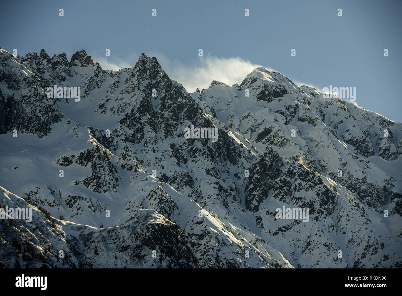 Wind blowing over snow capped mountain peaks Stock Photo - Alamy