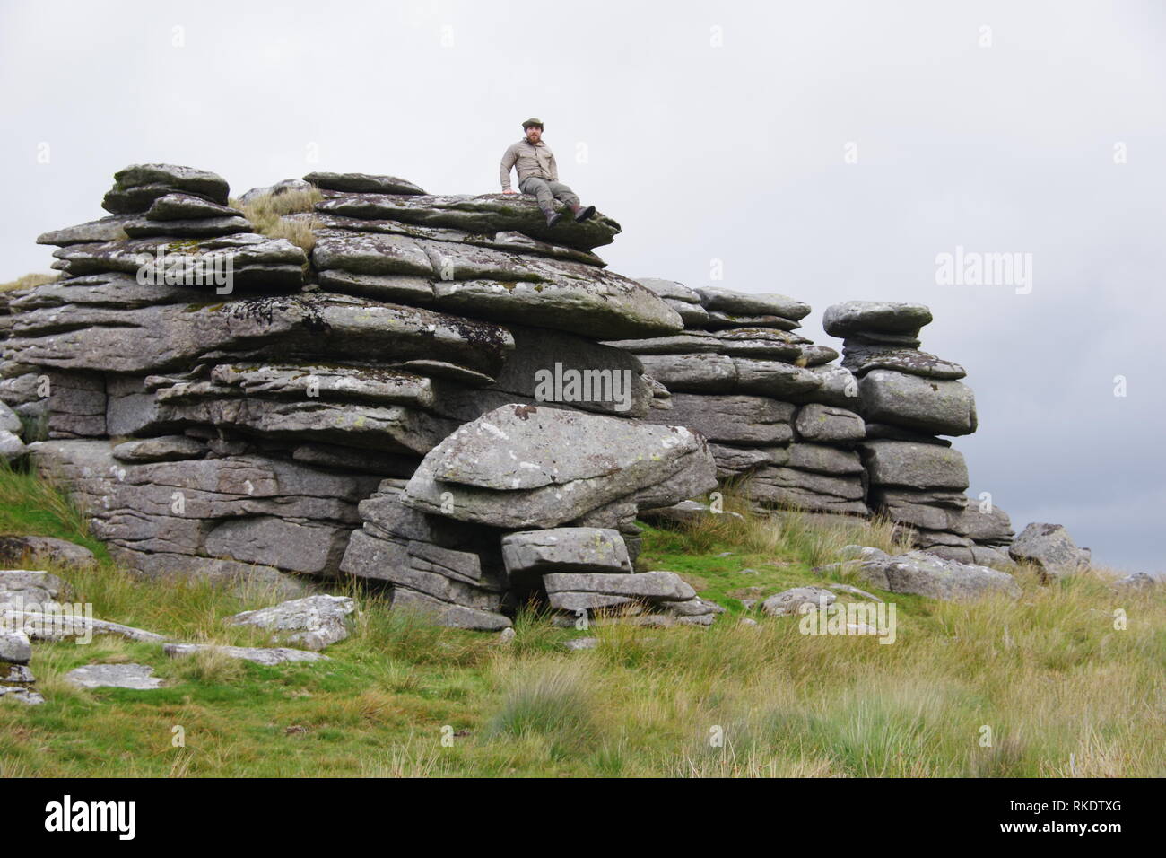 Outdoorsman Atop Littaford Tors, Cornubian Granite Tor on a Grey Day ...