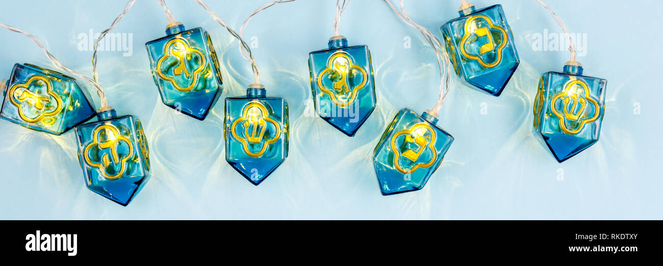 Blue background with lantern dreidels. Hanukkah and judaic holiday ...
