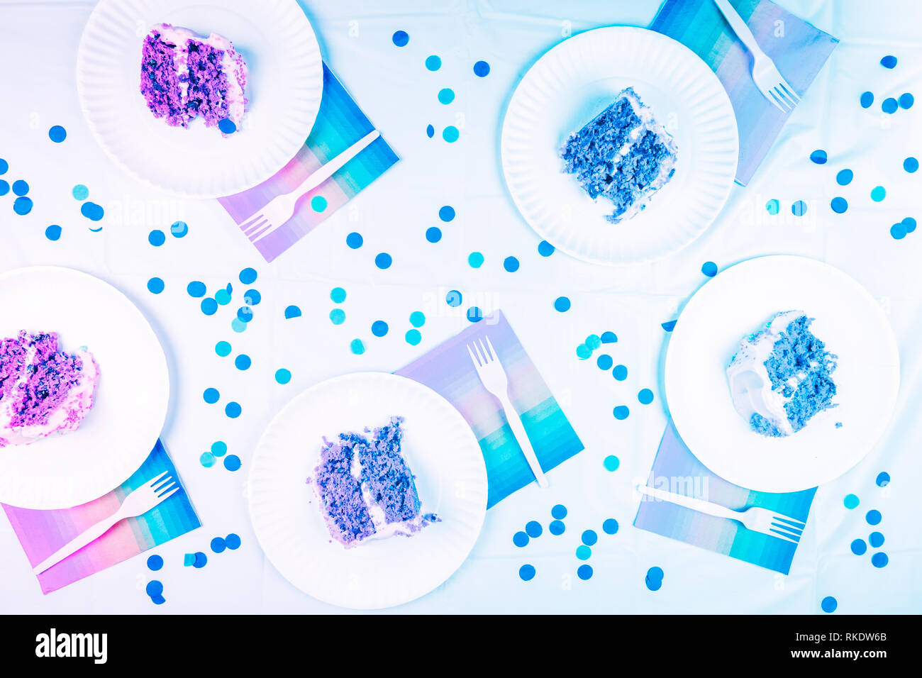 Flat lay with birthday cake pieces on white paper plates. Birthday ...
