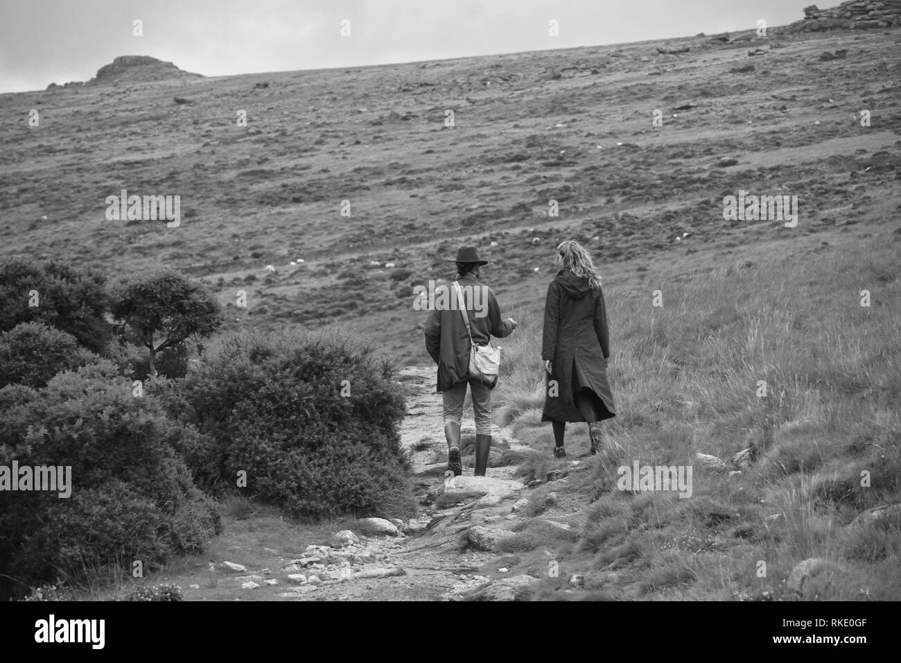 Young Couple in Traditional Country Wear Walk the Path to Wistmans Wood ...