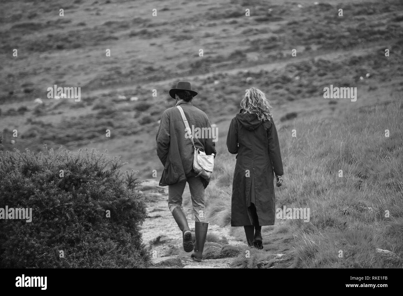 Young Couple in Traditional Country Wear Walk the Path to Wistmans Wood ...