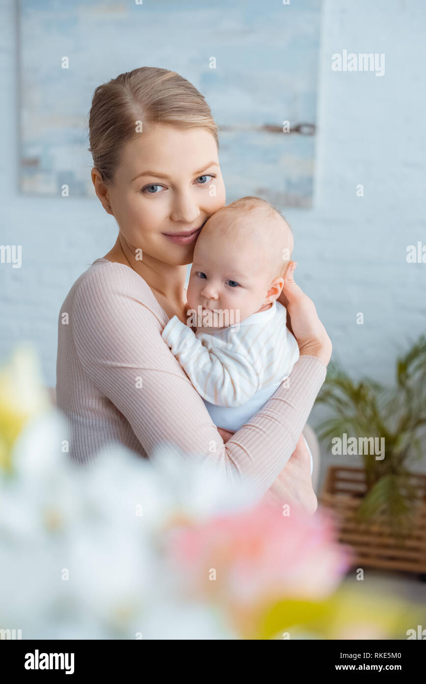 Hugging infant hi-res stock photography and images - Alamy