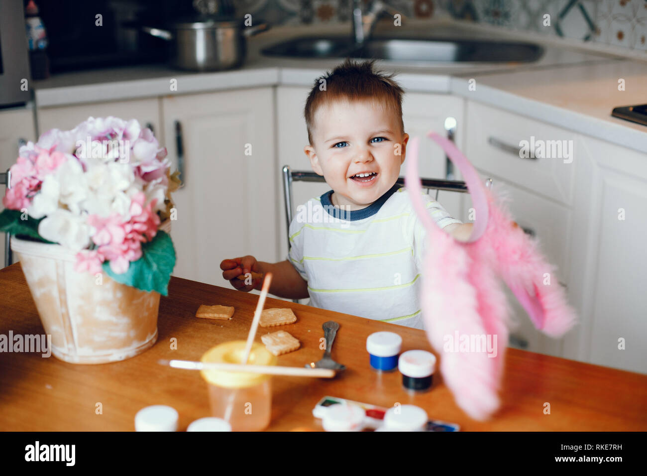 Little boy sitting in a kitchen Stock Photo - Alamy