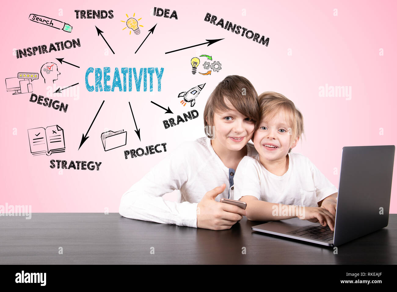 Creativity concept. Two boys with smartphone and laptop Stock Photo - Alamy
