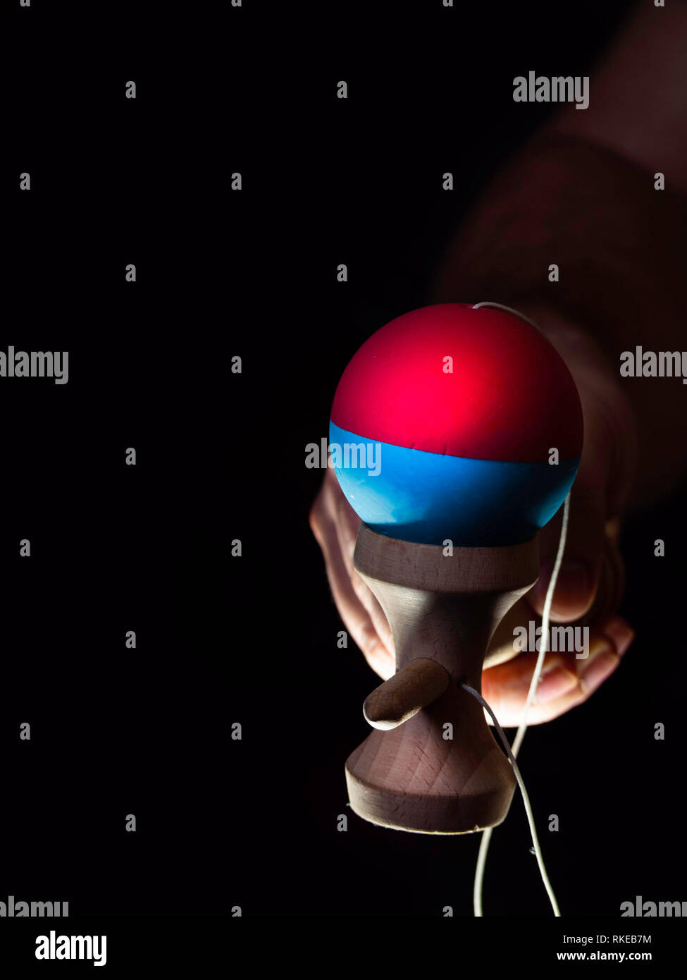 Kendama japanese toy in black background in hand Stock Photo - Alamy