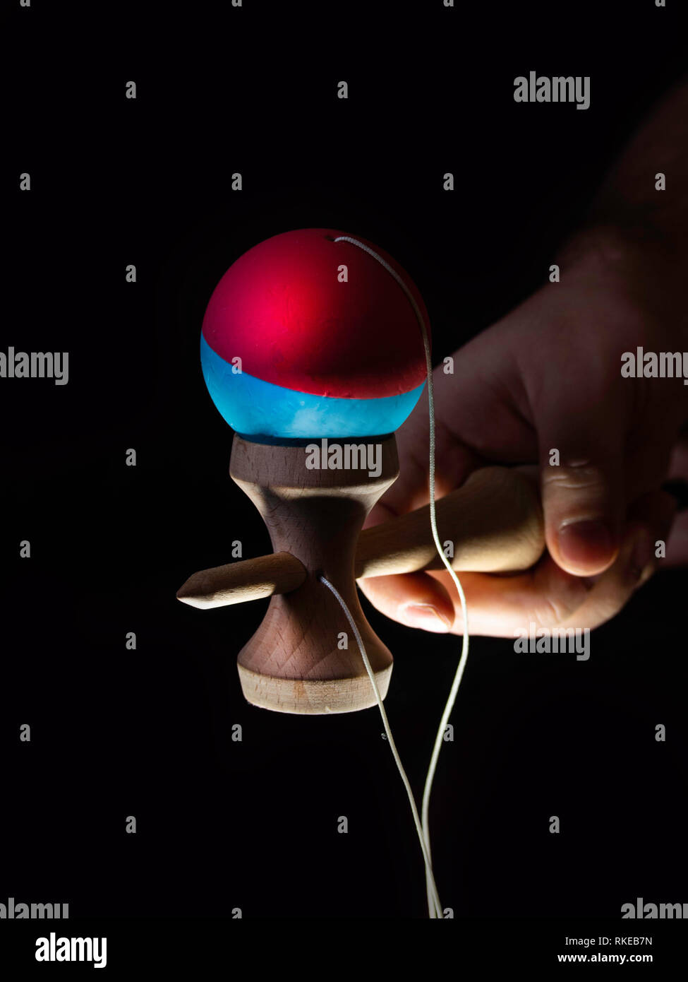 Kendama japanese toy in black background in hand Stock Photo - Alamy