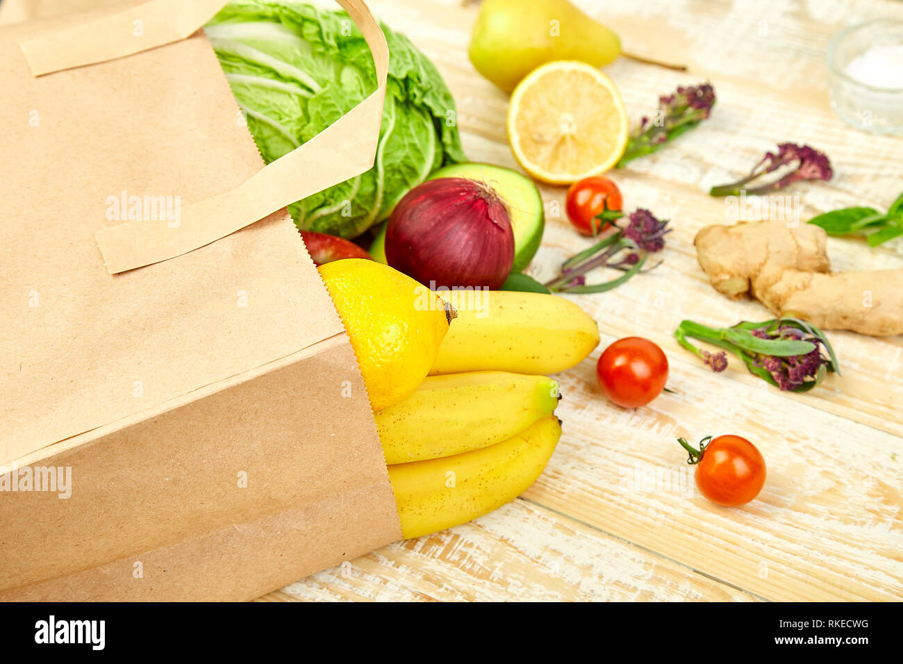 Grocering concept. Full paper bag of different fruits and vegetables ...