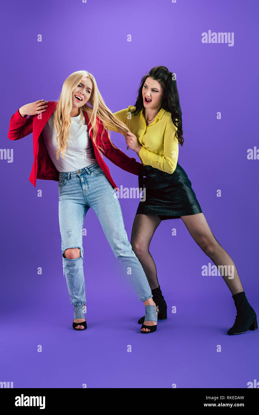 Aggressive girls yelling and fighting on purple background Stock Photo ...