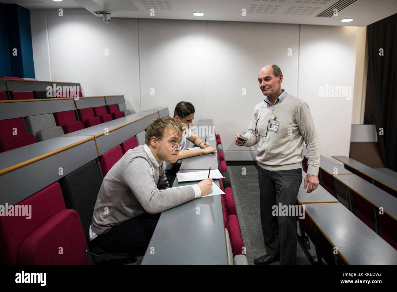 Man sitting supervised Mensa IQ test at University College London ...