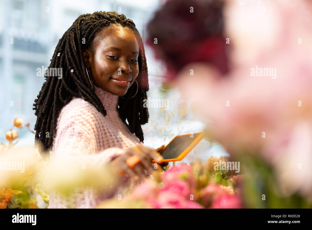 Cheerful brunette female pointing at fresh flowers Stock Photo - Alamy
