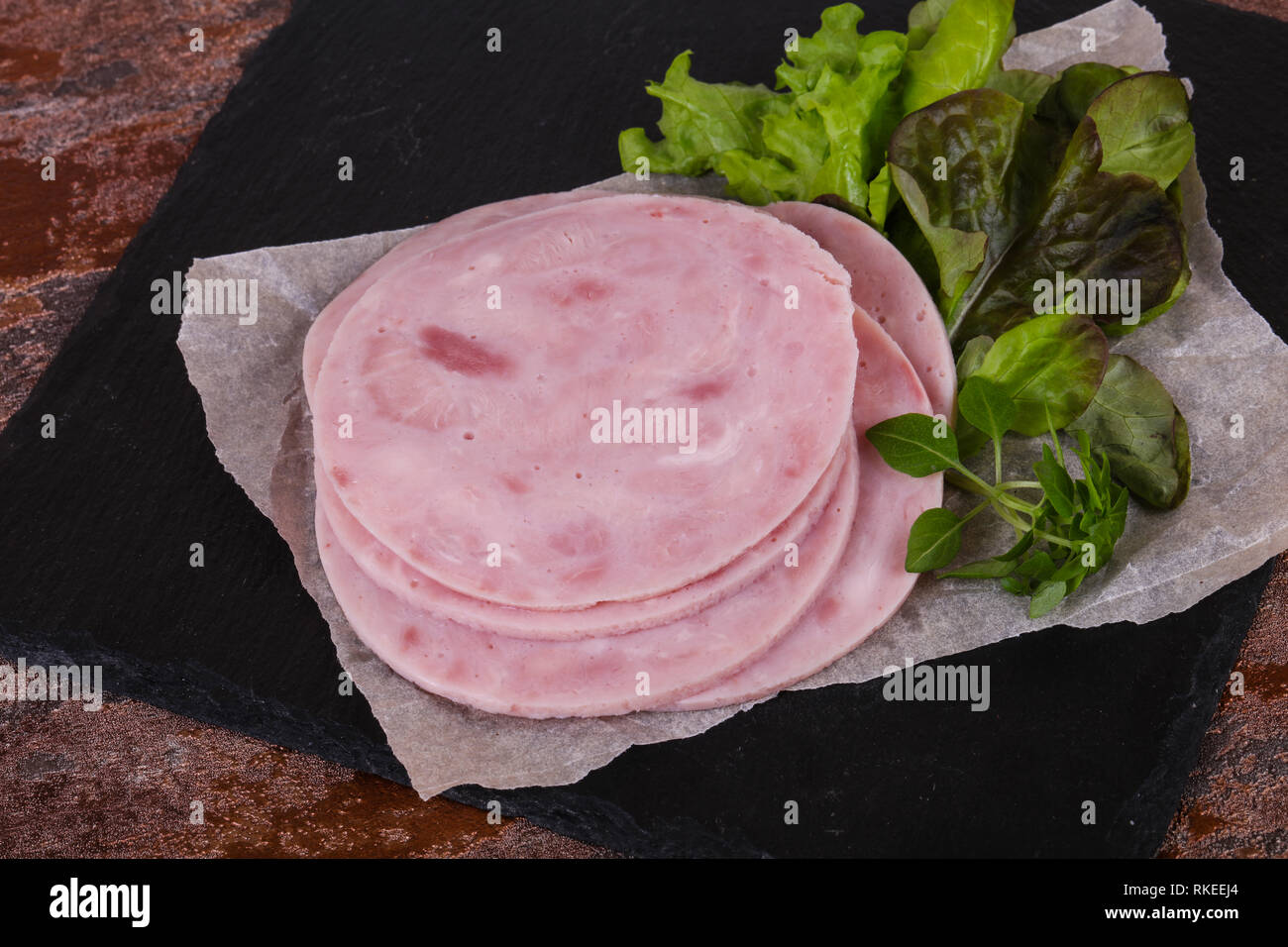 Sliced tasty Ham appetizer served salad leaves Stock Photo - Alamy