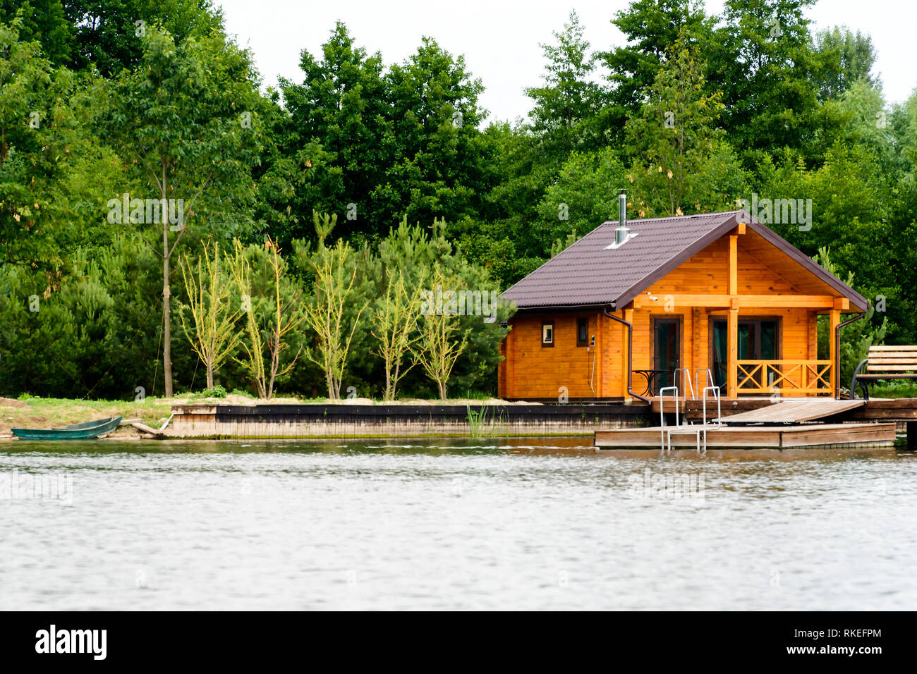 Beautiful wooden bath on the river bank. Weekend house. Eco tourism ...
