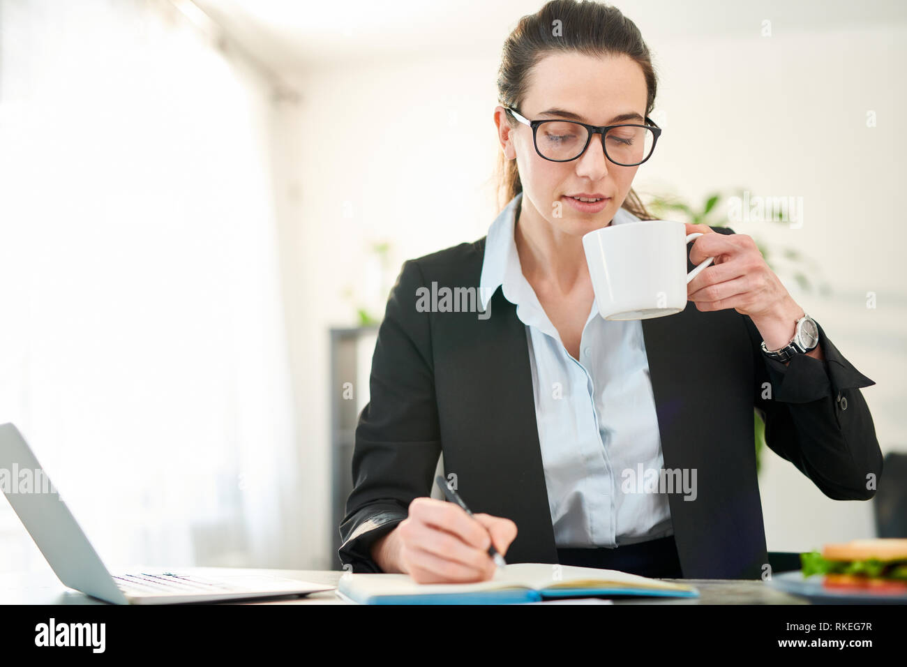 Young Businesswoman Drinking Coffee Stock Photo - Alamy
