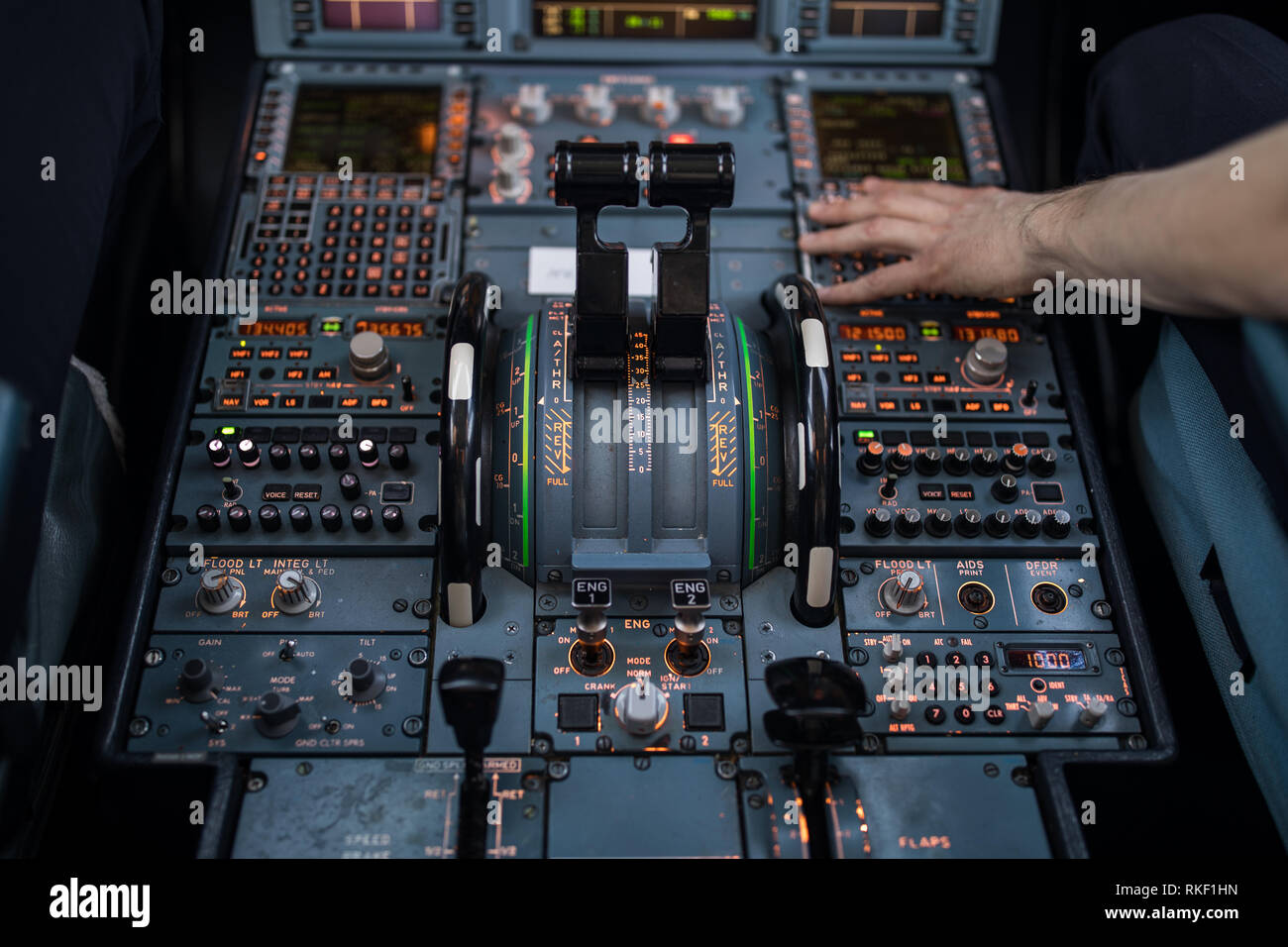 Pilot's hand accelerating on the throttle in a commercial airliner ...