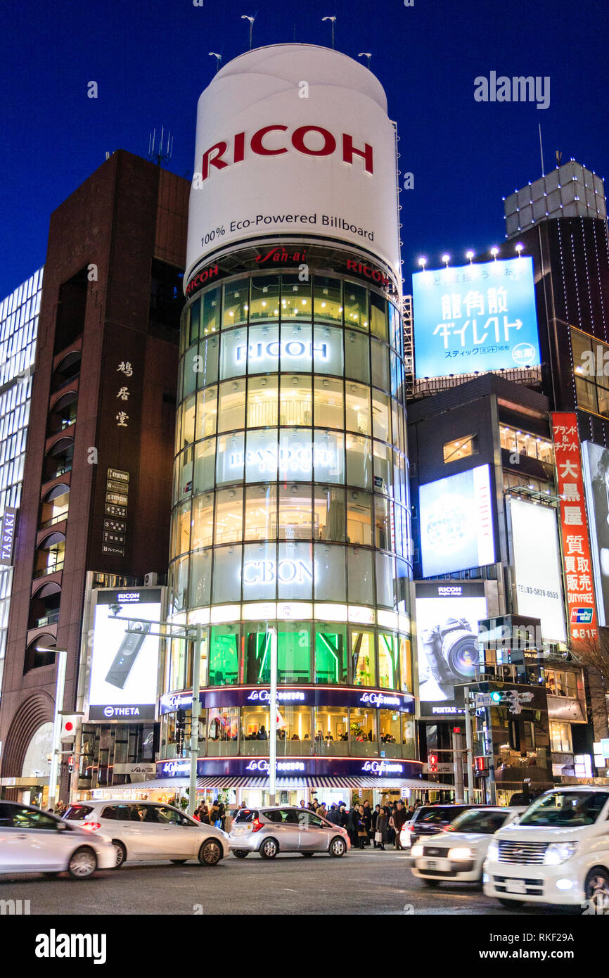 Tokyo, Ginza, night. 4-chome intersection, cars passing, with glass ...