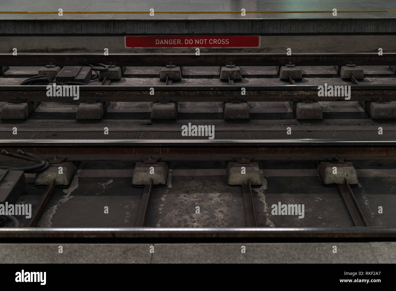 Red do not cross sign in an underground metro station by the rail ...