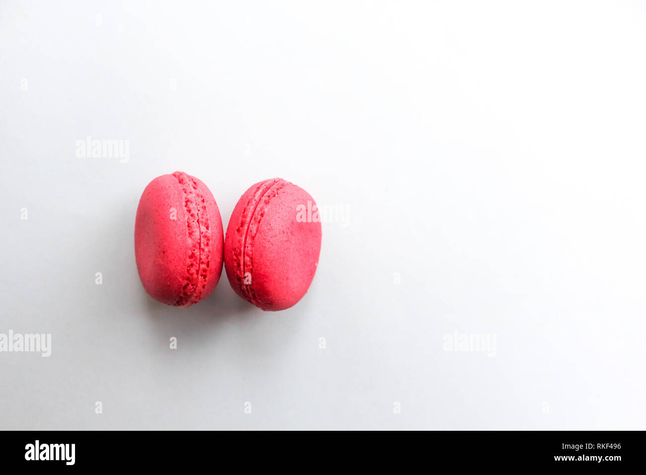 Two pink macaroons on a light blue background, minimal food concept ...