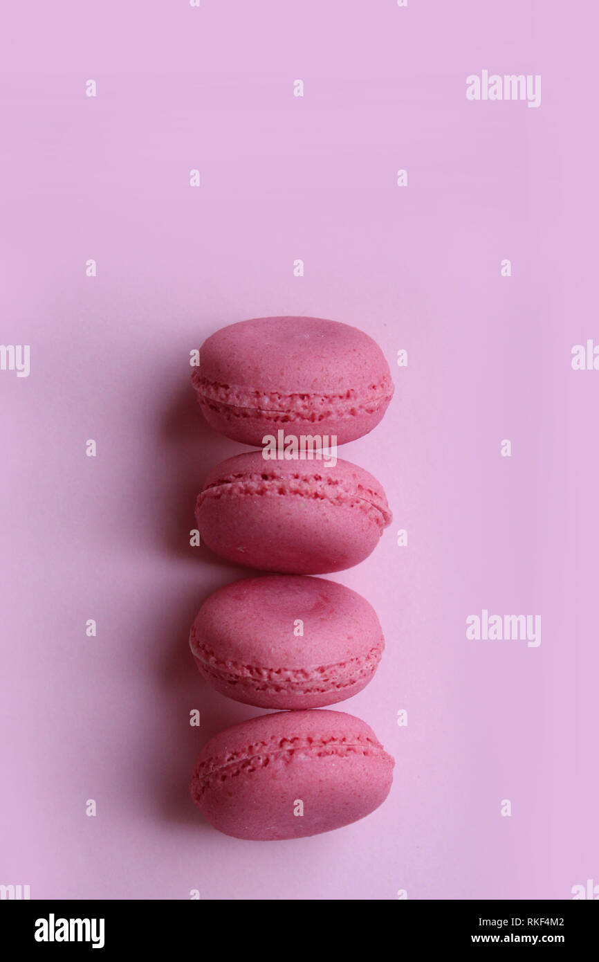 Four pink macaroons on a light pink background, vertical Stock Photo ...