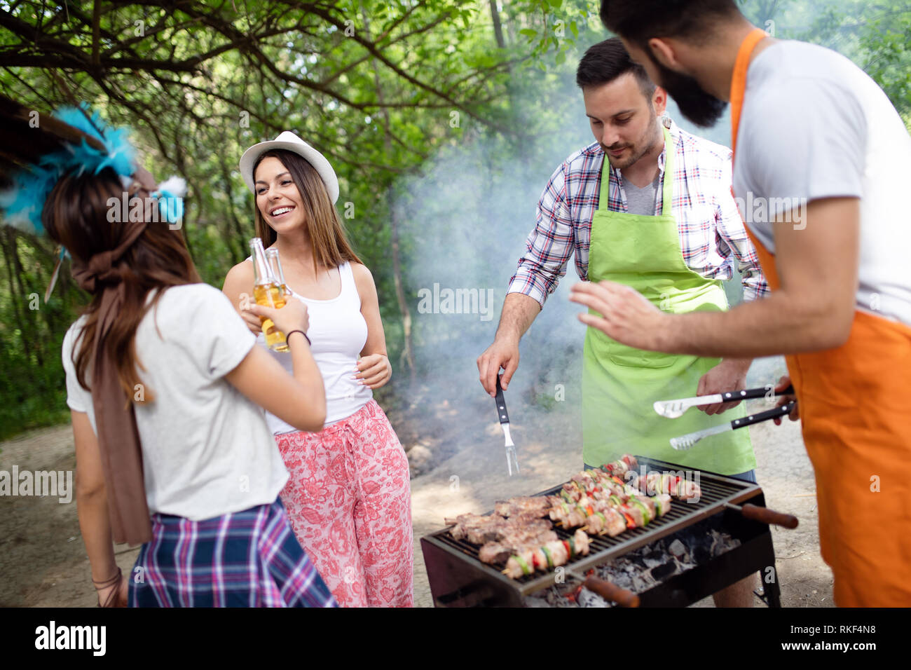 Group of friends having a barbecue party in nature Stock Photo - Alamy