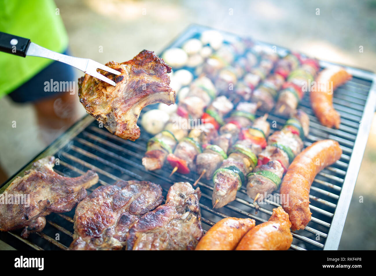 Assorted meat from chicken, pork and various vegetables on barbecue ...