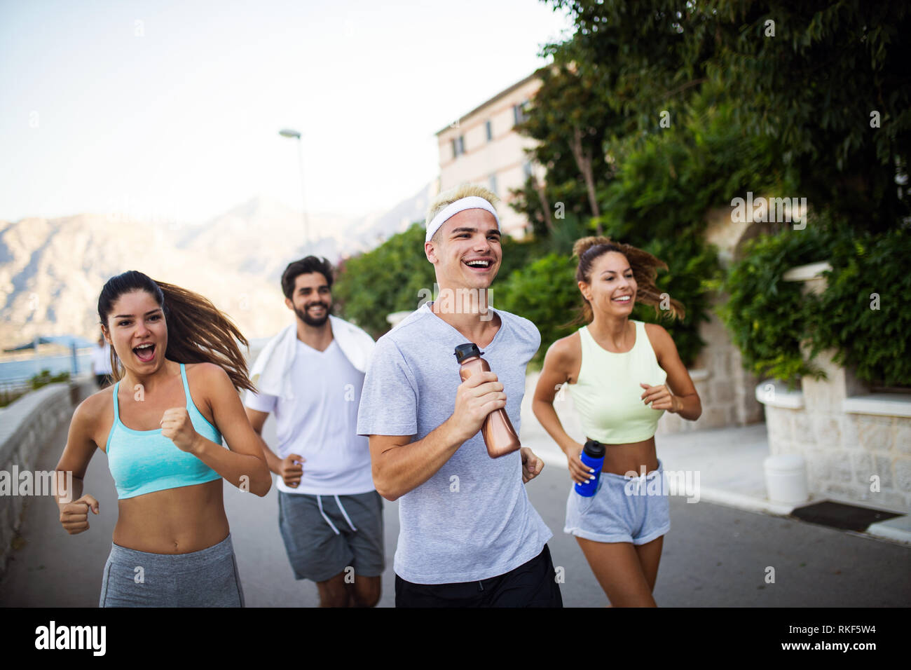 Group of young people friends running outdoors at seaside Stock Photo ...