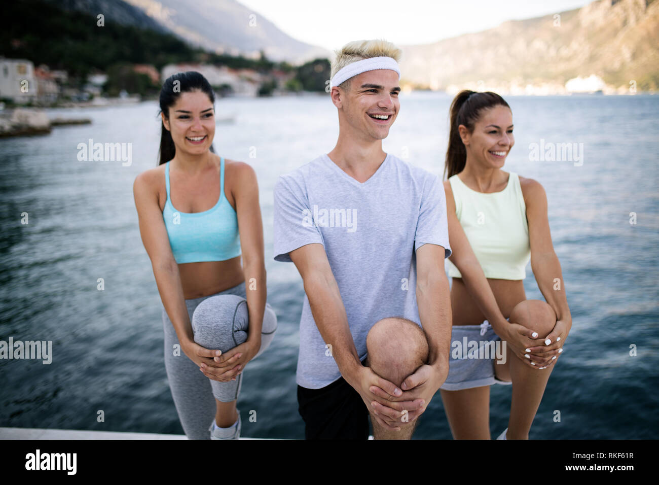 Group of happy people exercising outdoor. Sport, fitness, friendship ...