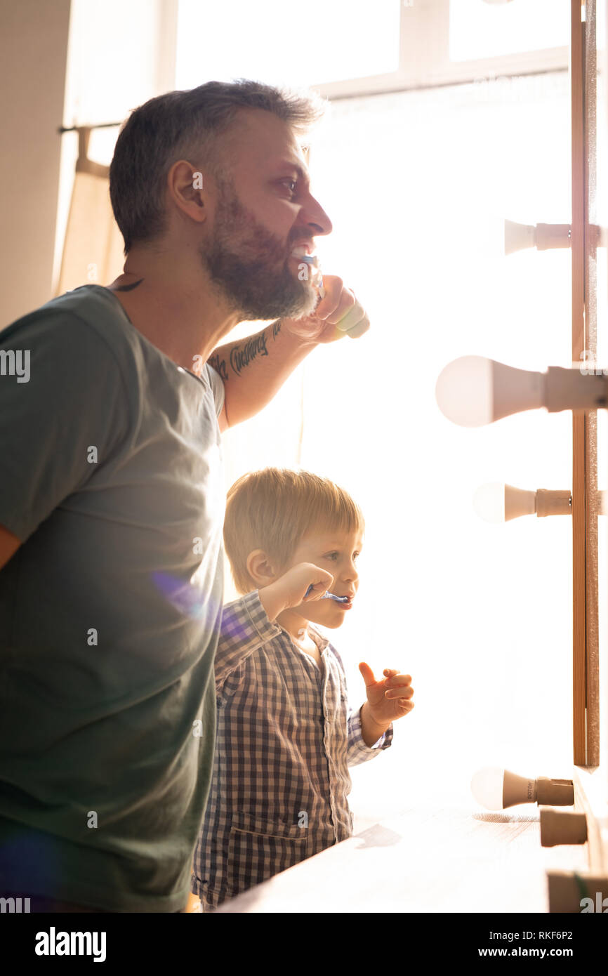 Family brushing teeth in bathroom Stock Photo - Alamy