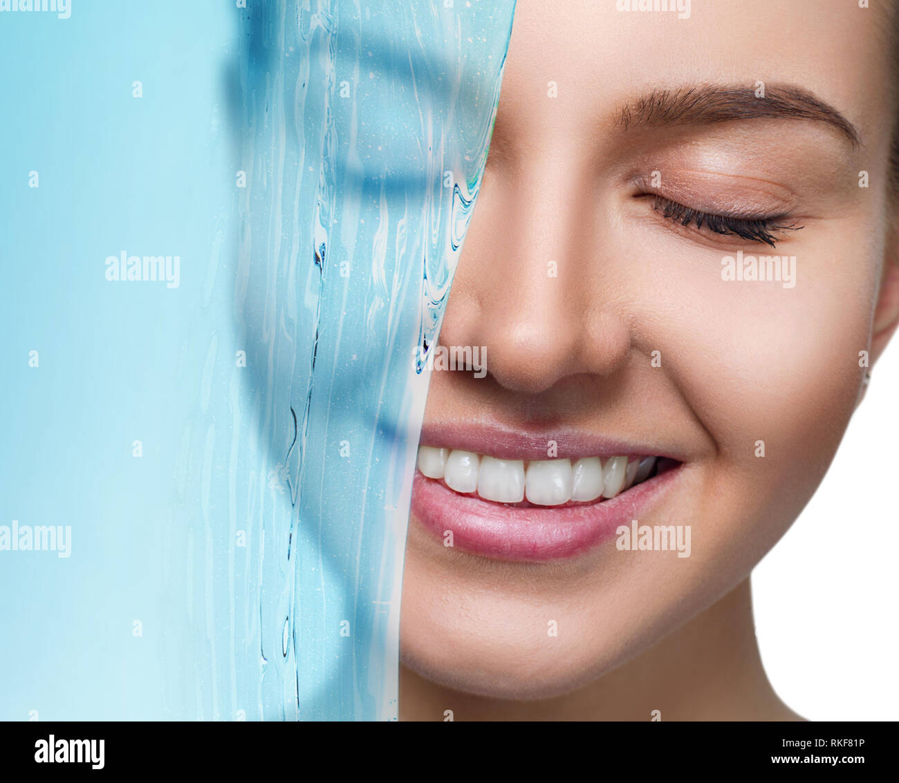 Sensual woman under water splash over white background. Cleansing and ...