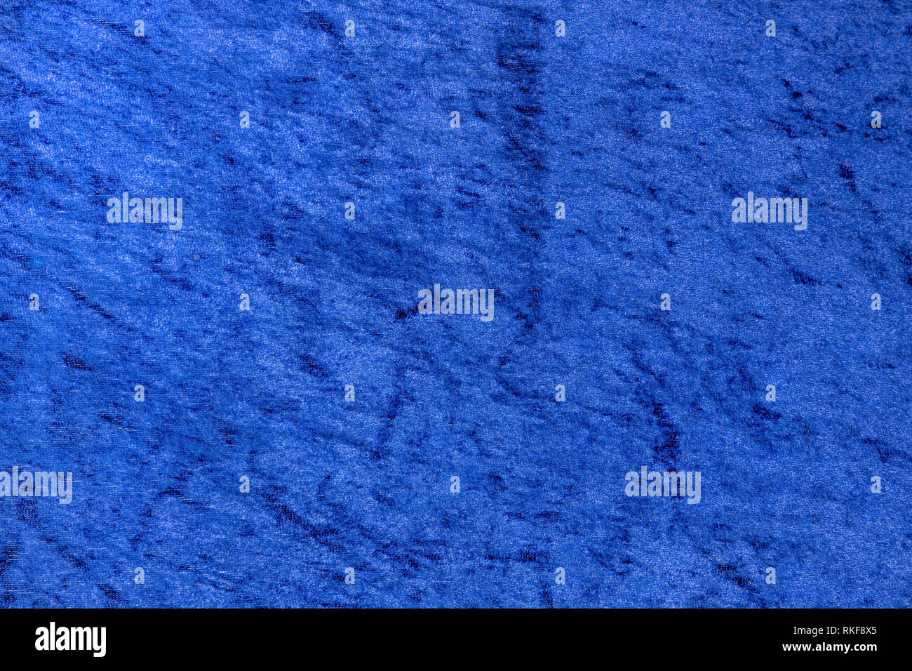 Light blue shiny even velvet fabric format filling as a background ...