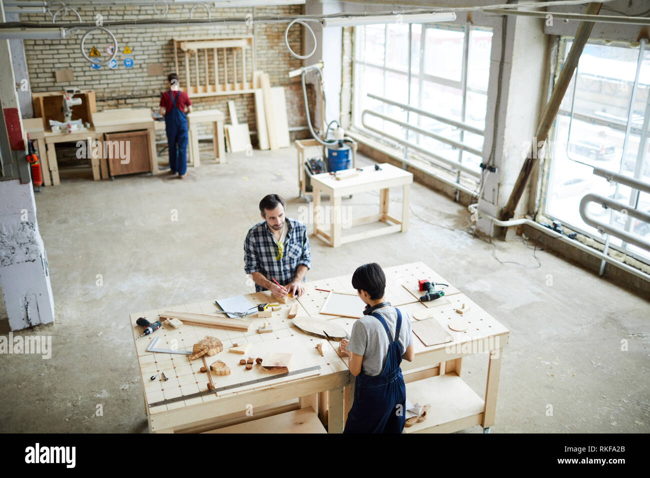 Carpentry workers making wooden frames in workshop Stock Photo - Alamy