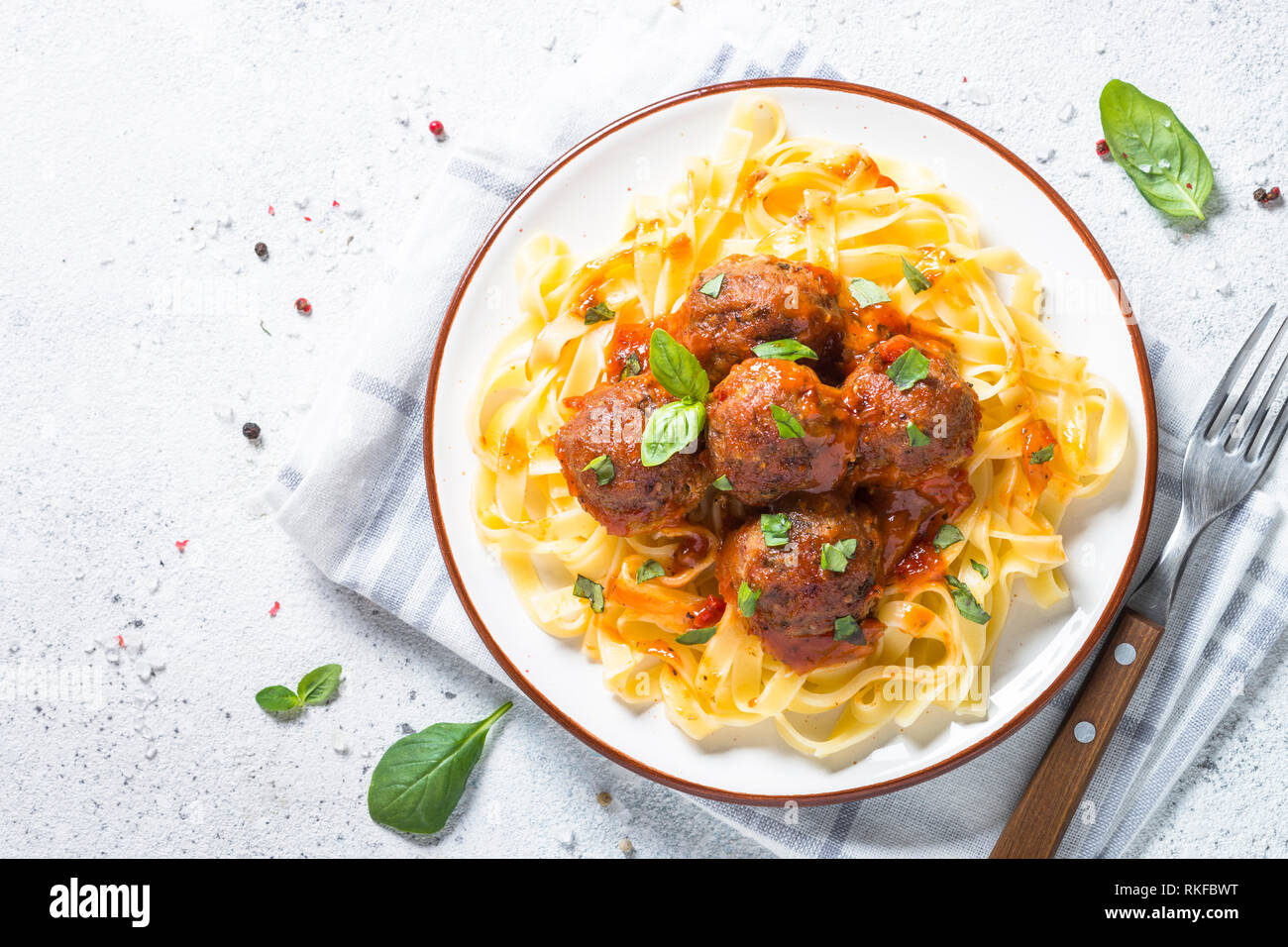 Meatballs in tomato sauce with pasta tagliatelle top view Stock Photo ...