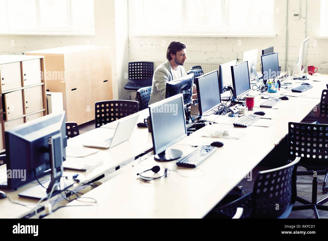 Male office worker looking at computer screen with data. Concept of ...