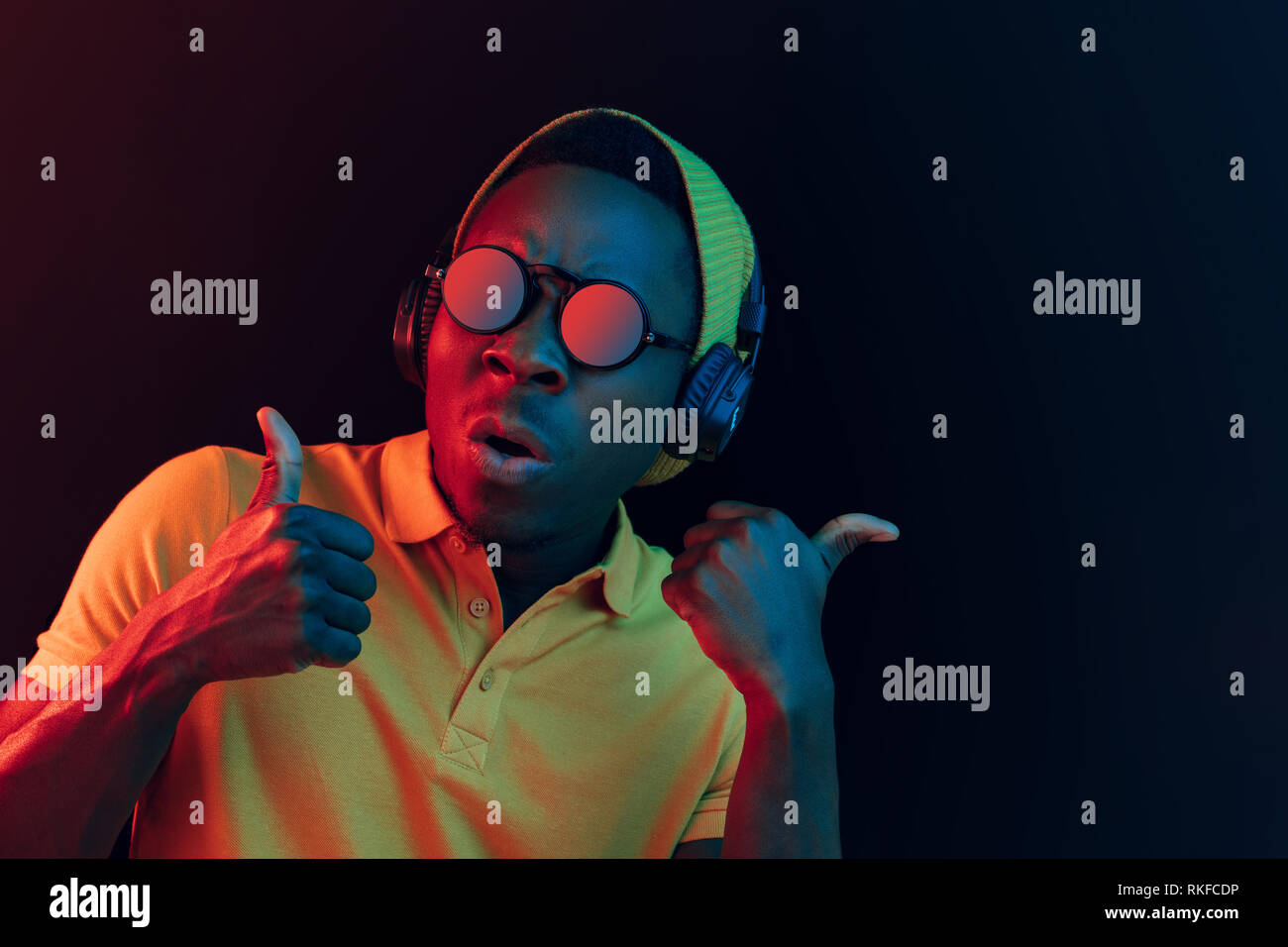 The young handsome serious sad hipster man listening music with ...