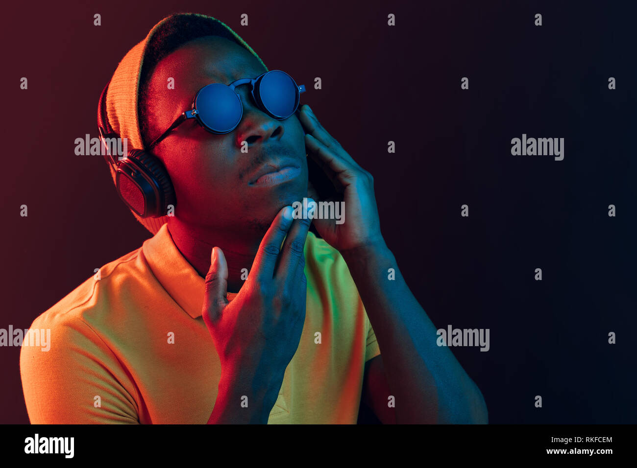 The young handsome serious sad hipster man listening music with ...