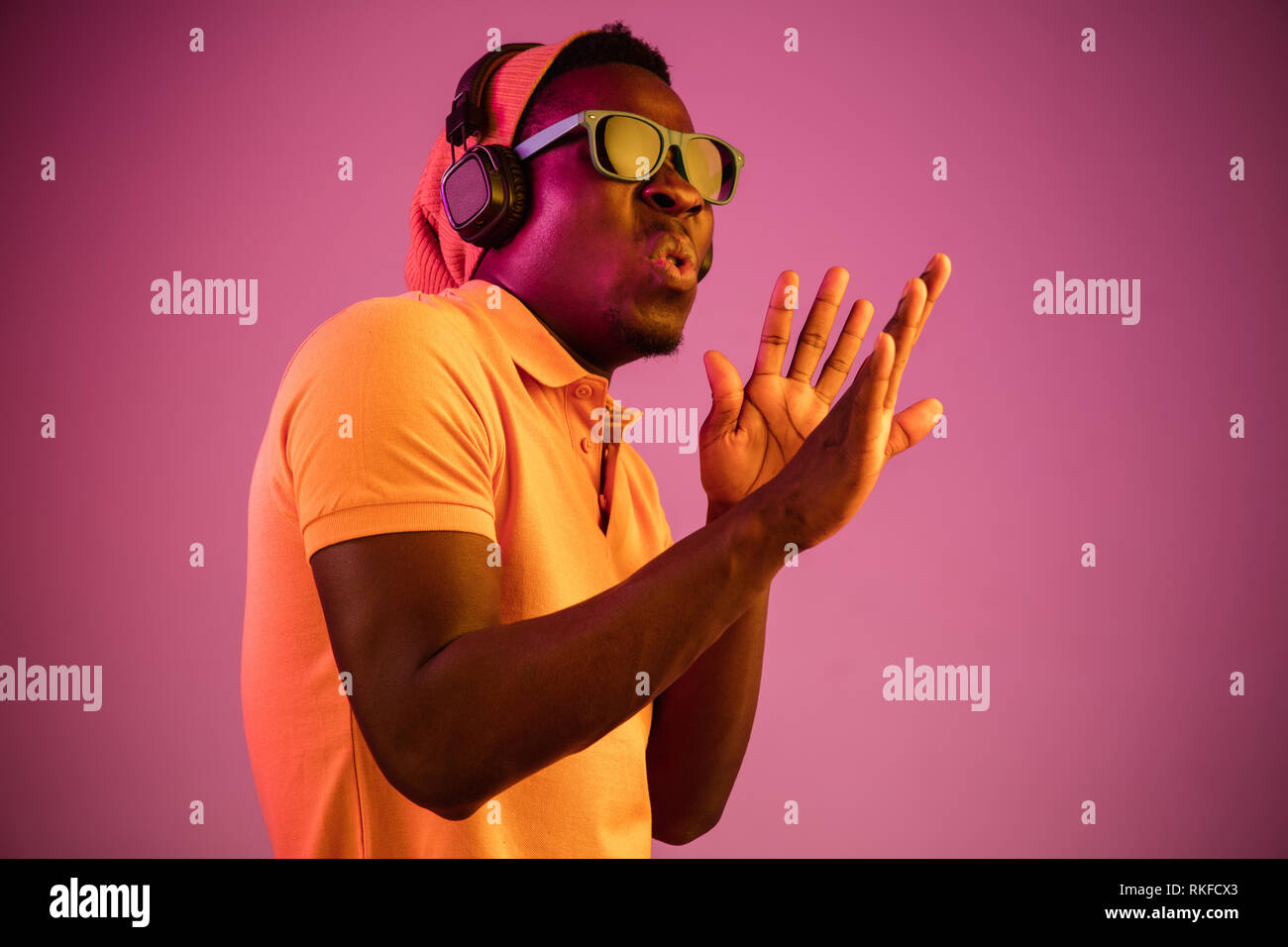 The young handsome serious sad hipster man listening music with ...