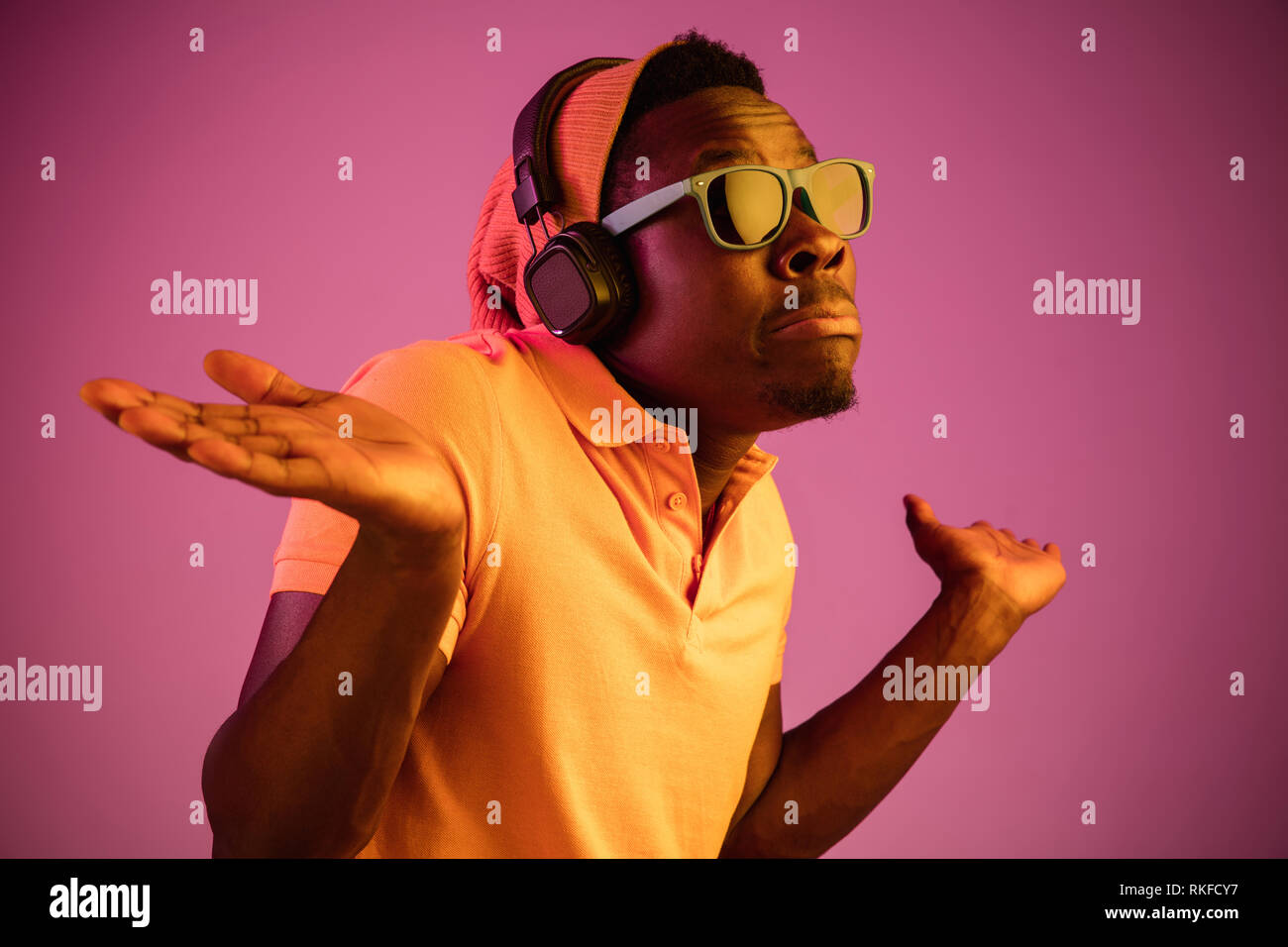 The young handsome serious sad hipster man listening music with ...