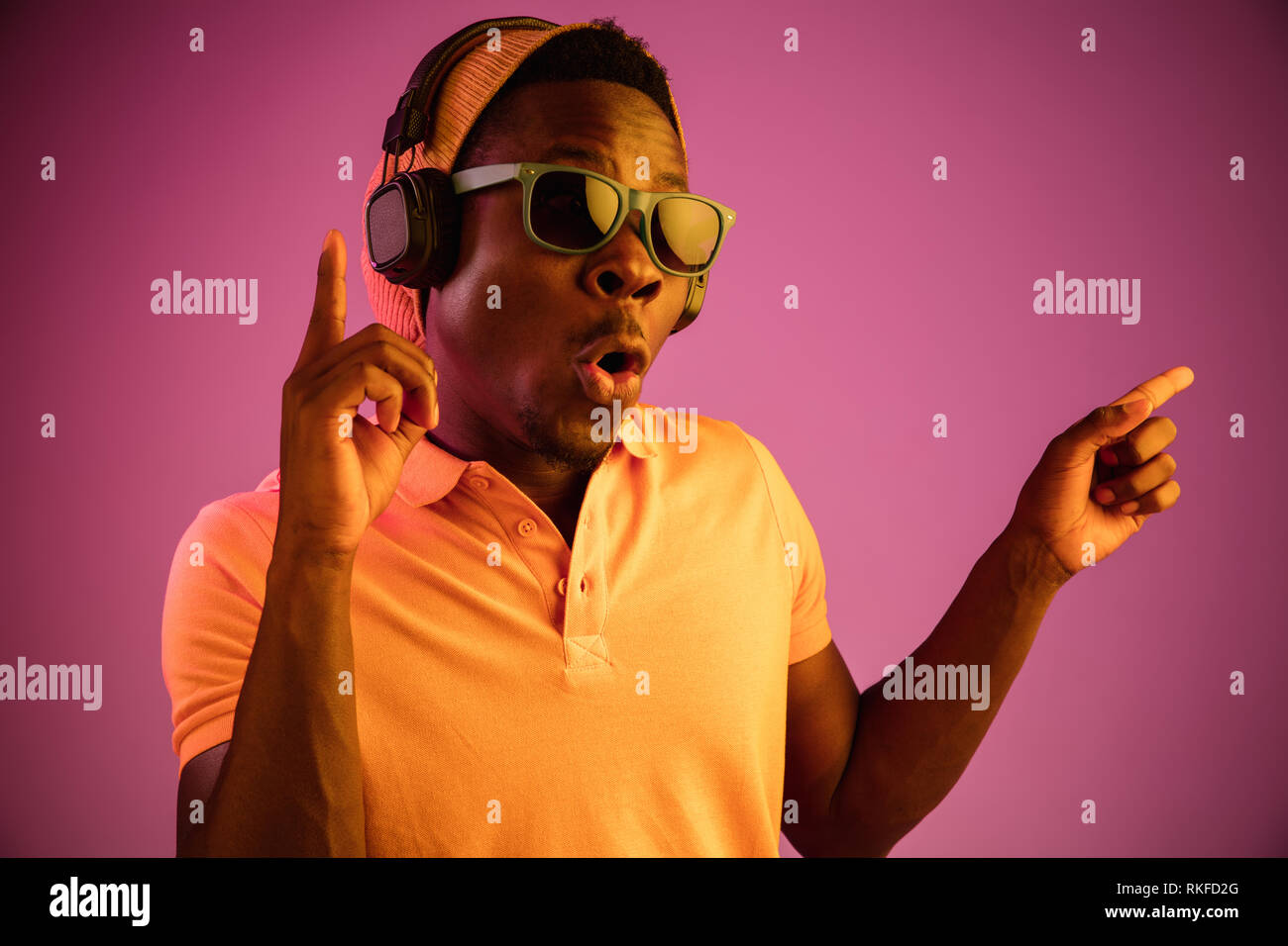 The young handsome happy surprised hipster man listening music with ...