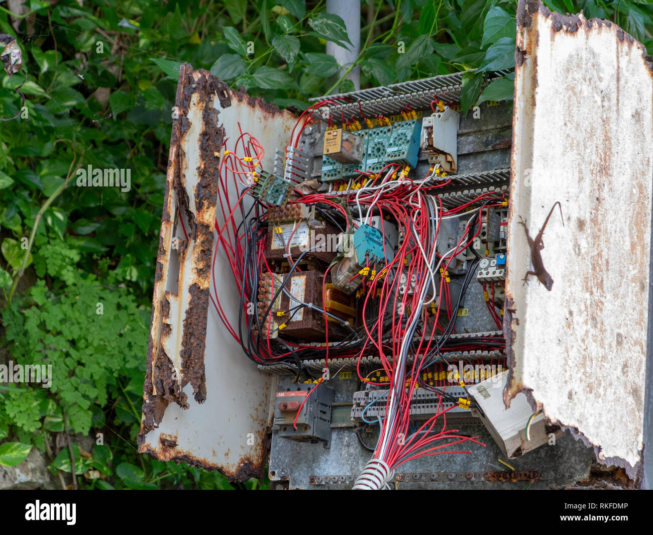 Chaotic open rusty wiring box Stock Photo - Alamy