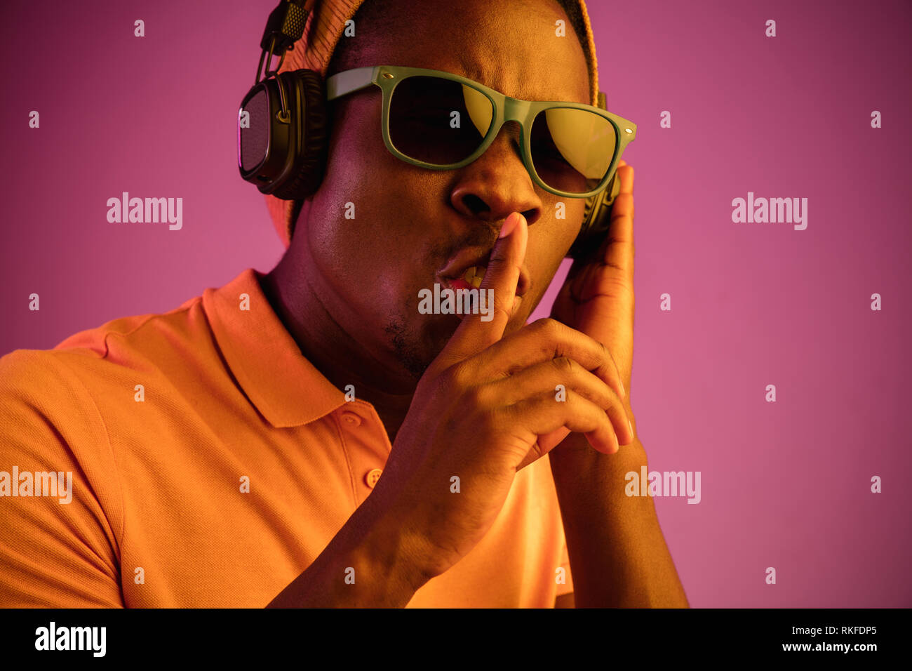 The young handsome happy hipster man listening music with headphones at ...