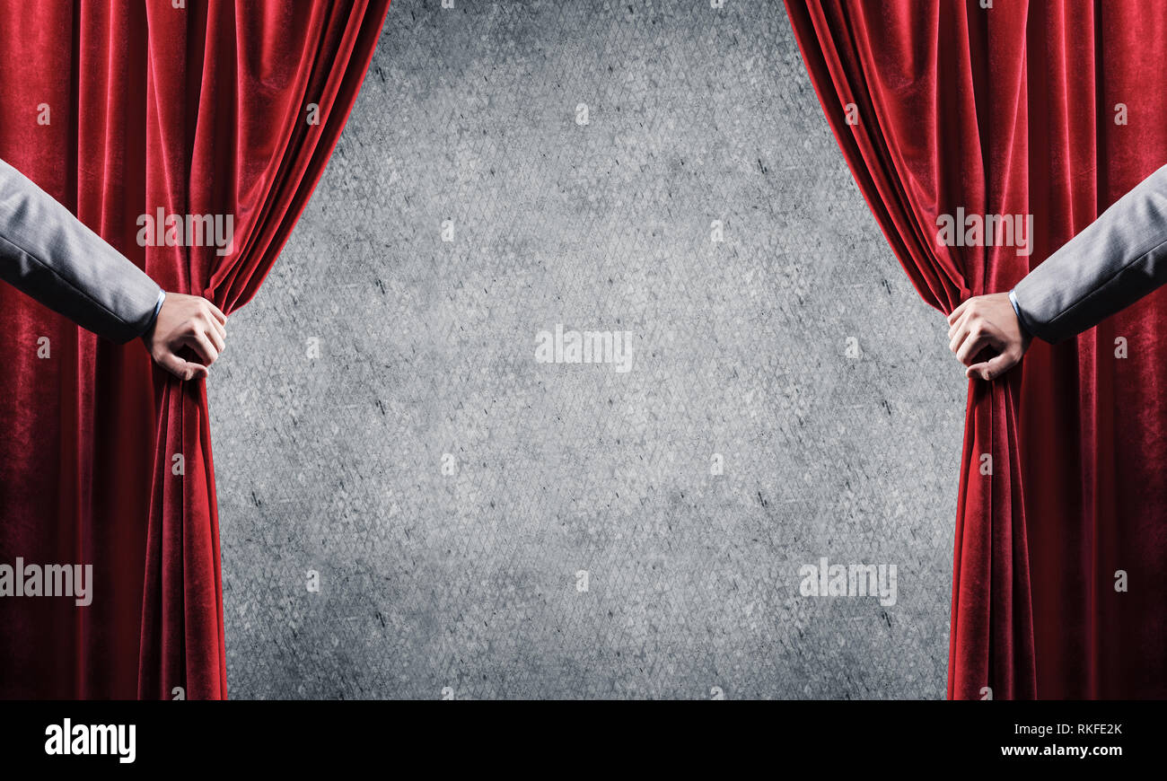 Concrete wall behind drapery curtain and hand opening it Stock Photo ...