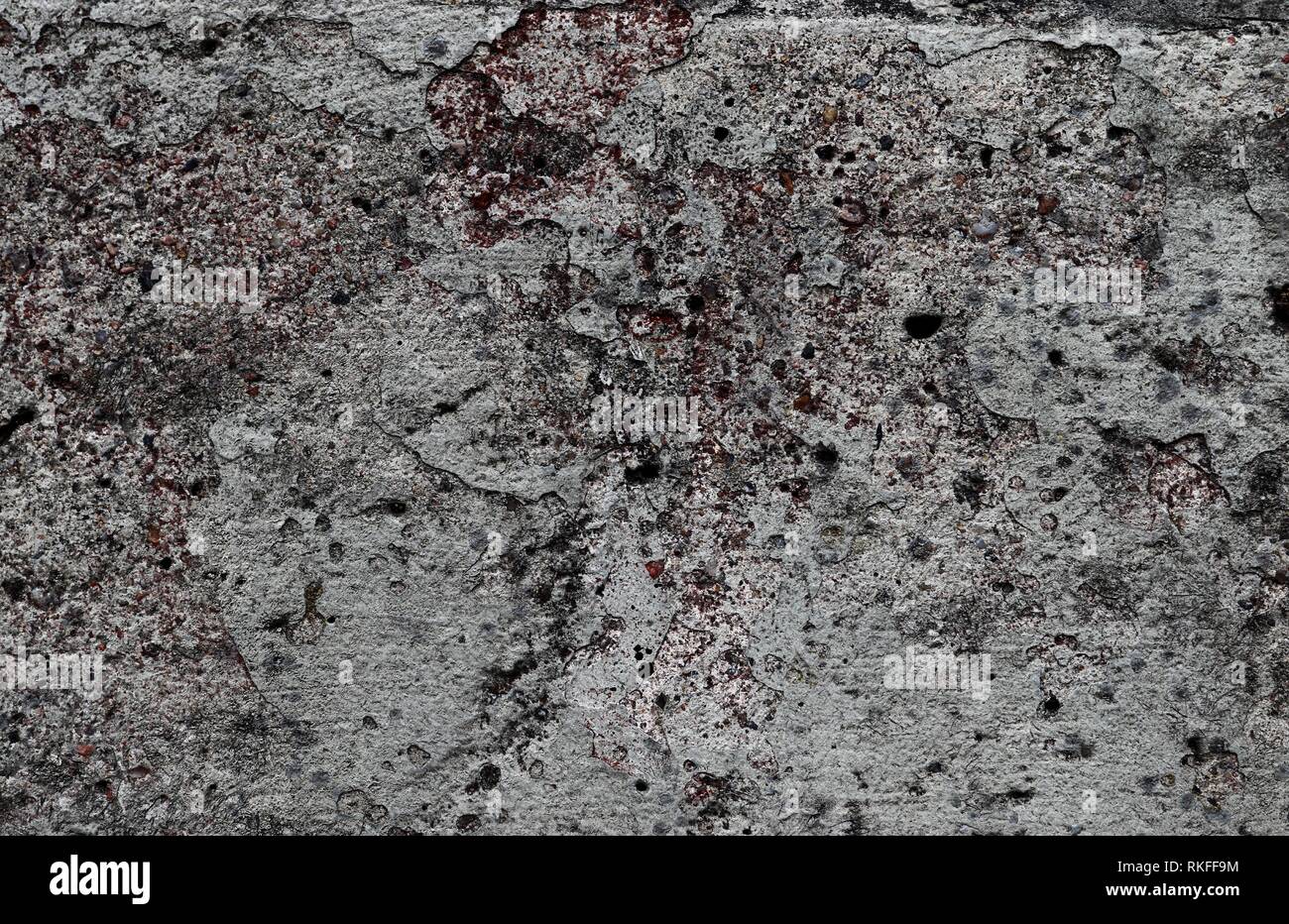 Close up of cracks in aged weathered cement and concrete walls of ...