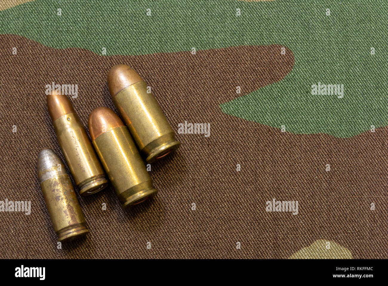 Vintage pistol bullets on military camouflage seamless pattern ...