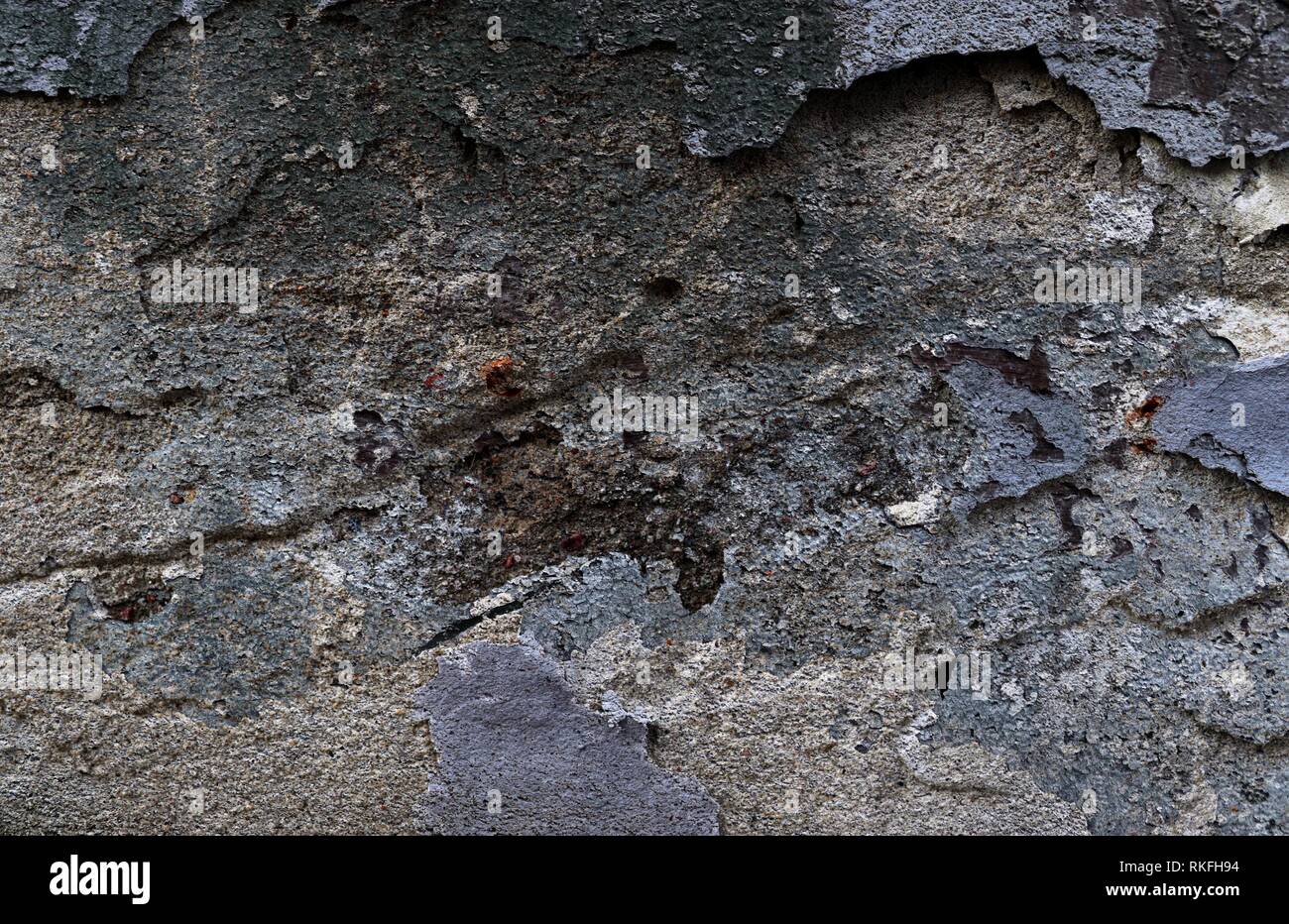 Close up of cracks in aged weathered cement and concrete walls of ...