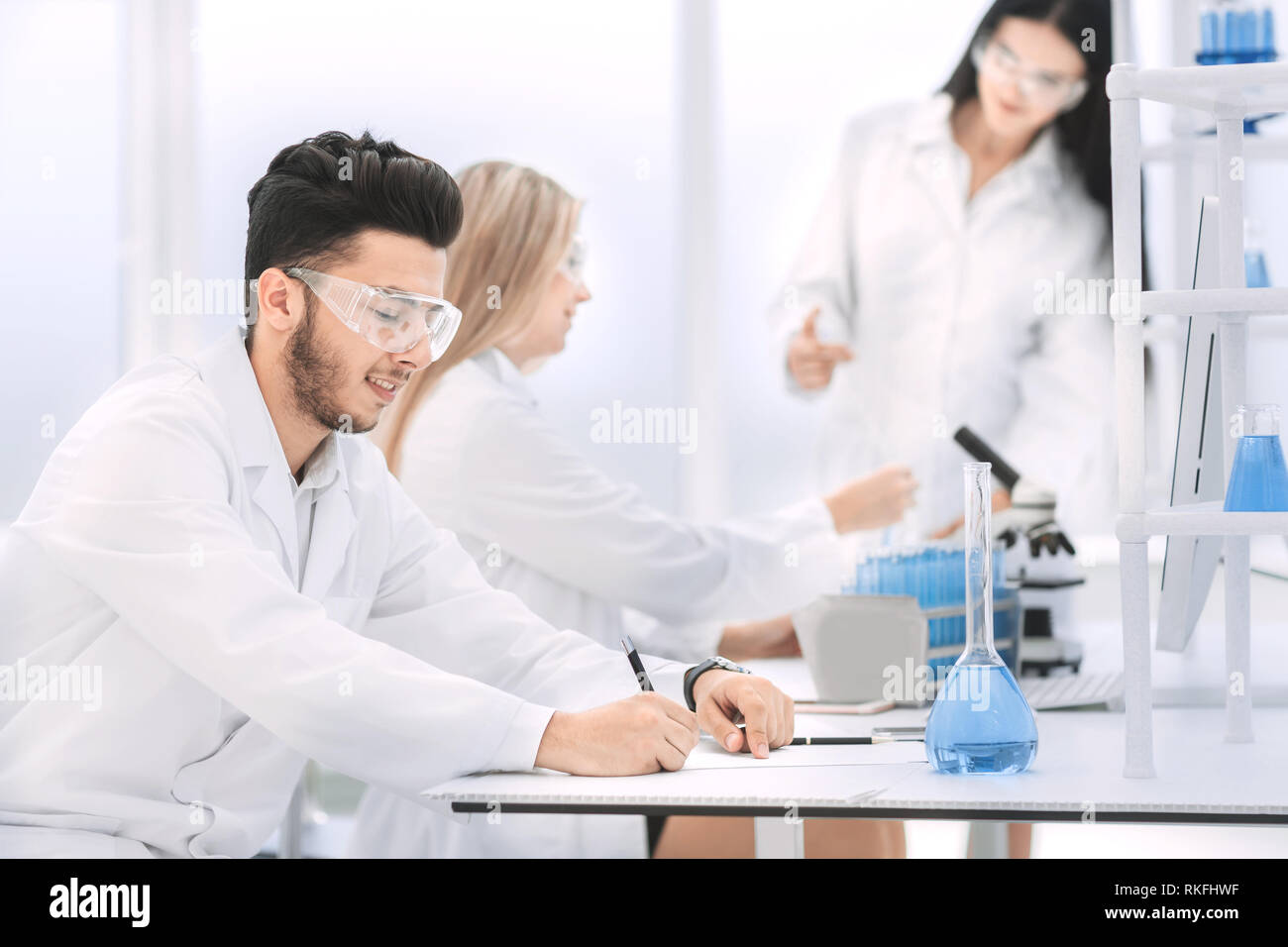 close up.young scientist sitting at his Desk in the laboratory Stock ...
