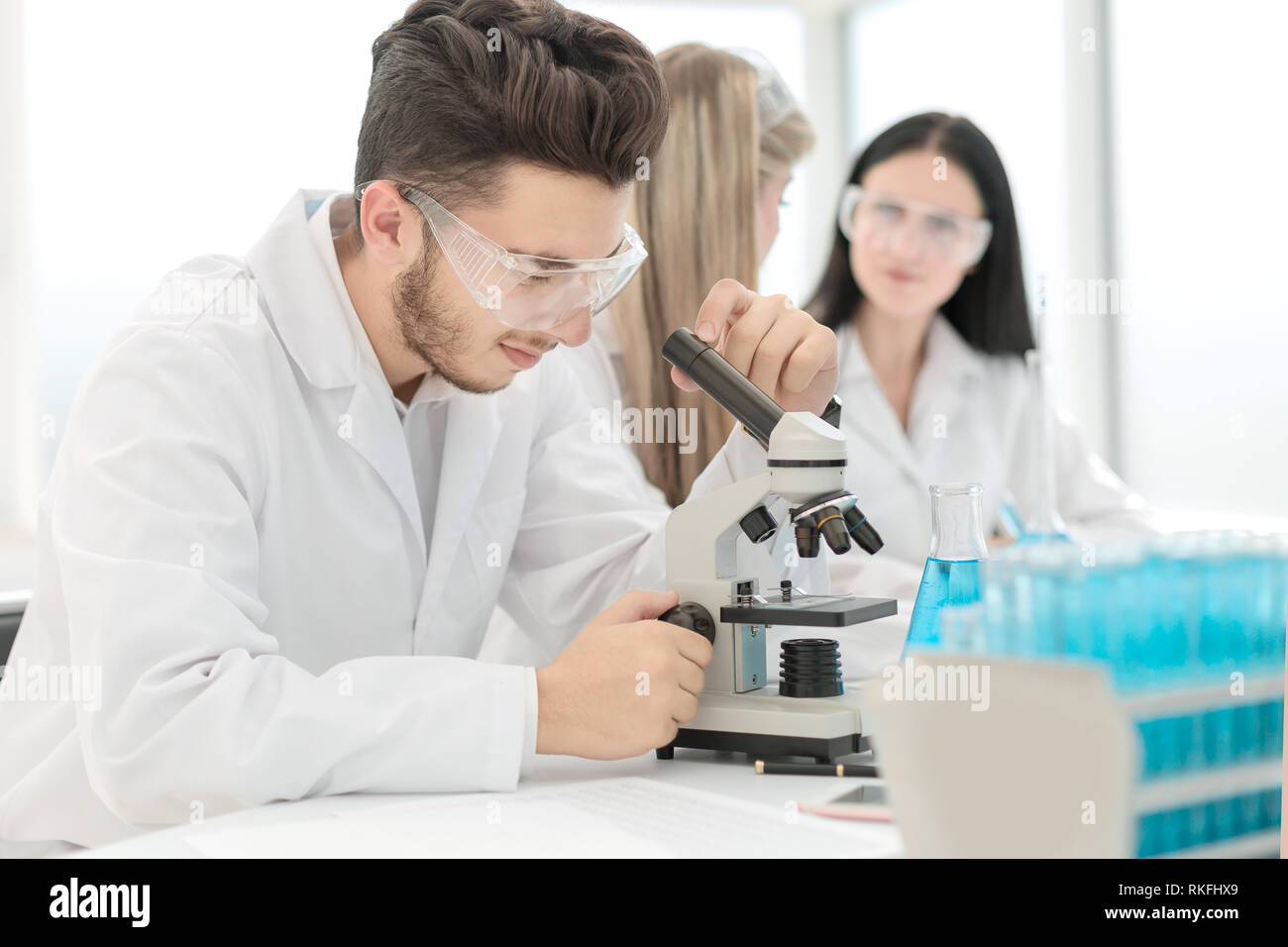 scientists biologists sitting at the laboratory table Stock Photo - Alamy