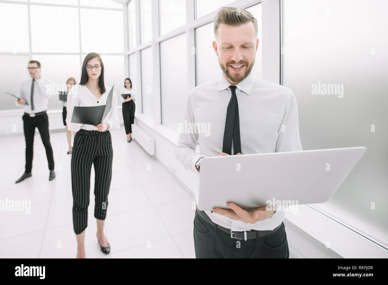 Executive employees of the company standing in the office lobby Stock ...