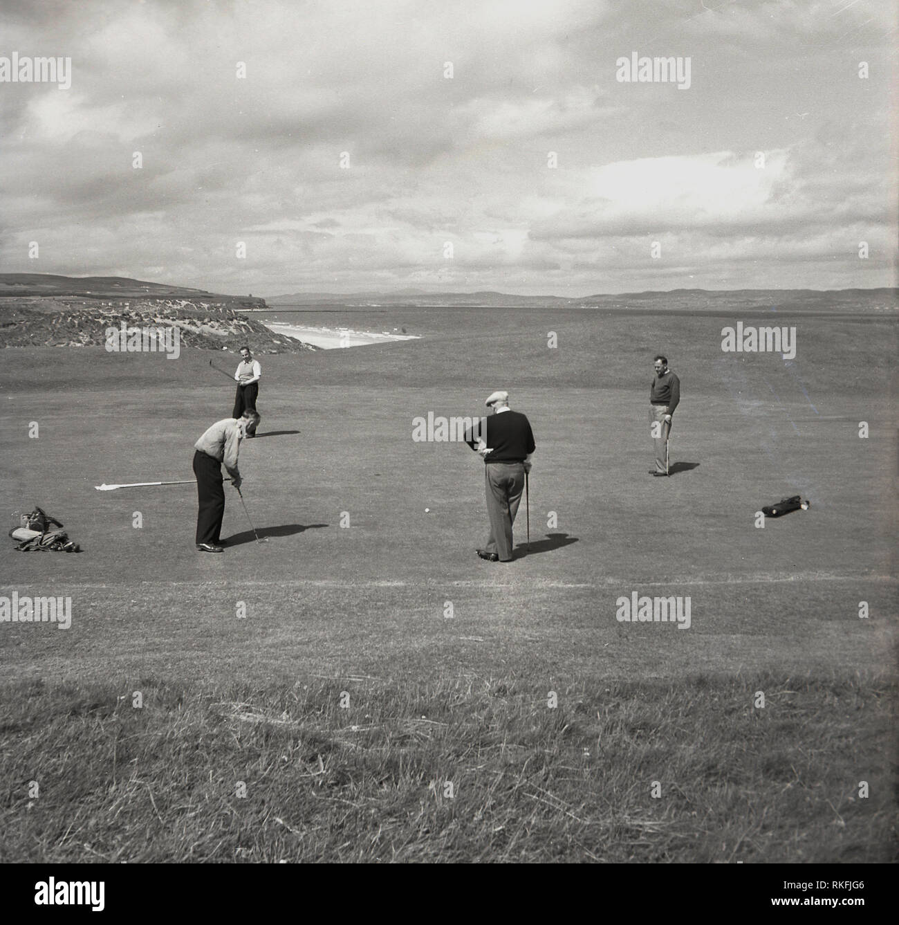 1950s, historical, playing golf on the Antrim Coast in Northern Ireland ...
