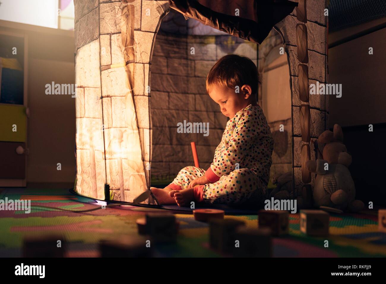 Little boy playing into castle toy at home. Childhood Concept Stock ...